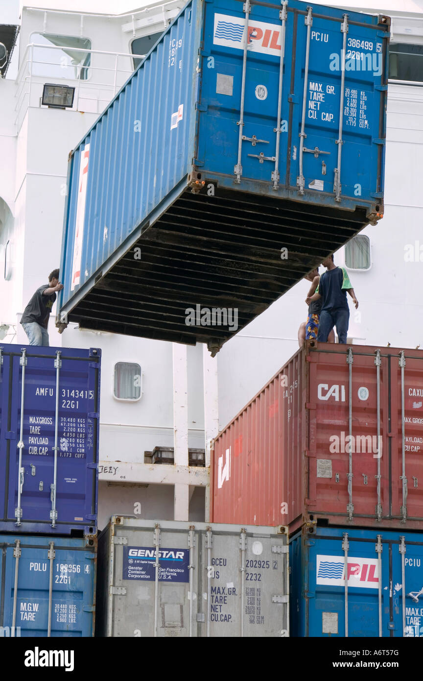 Tuvaluan workers loading containers onto the supply ship on Funafuti ...