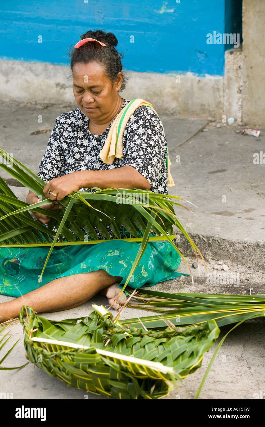 a tuvaluan lady weaves plates out of coconut palm leaves for a funeral ...