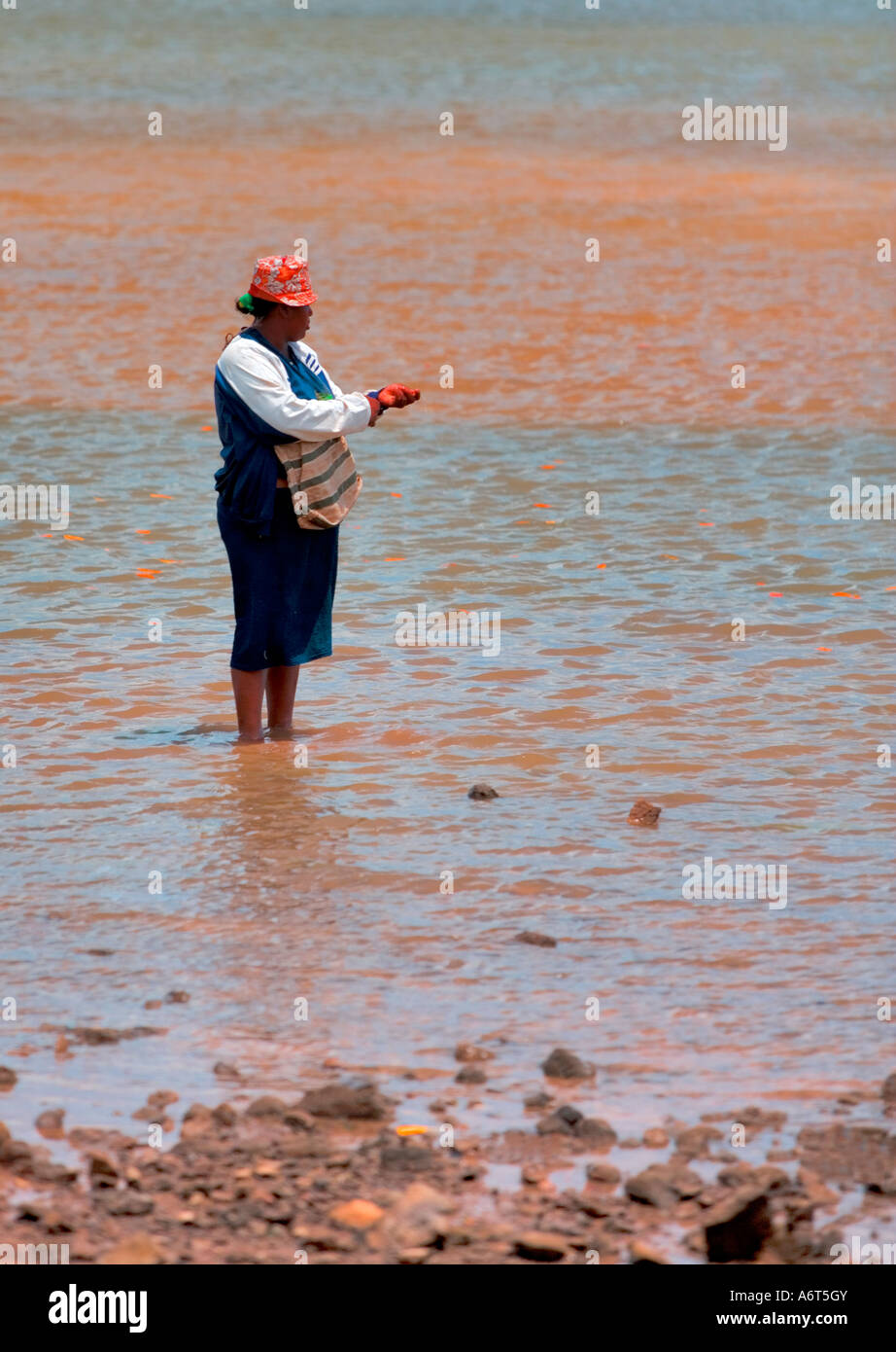 A familiar sight - lady fishing in "Rodrigues Stock Photo - Alamy