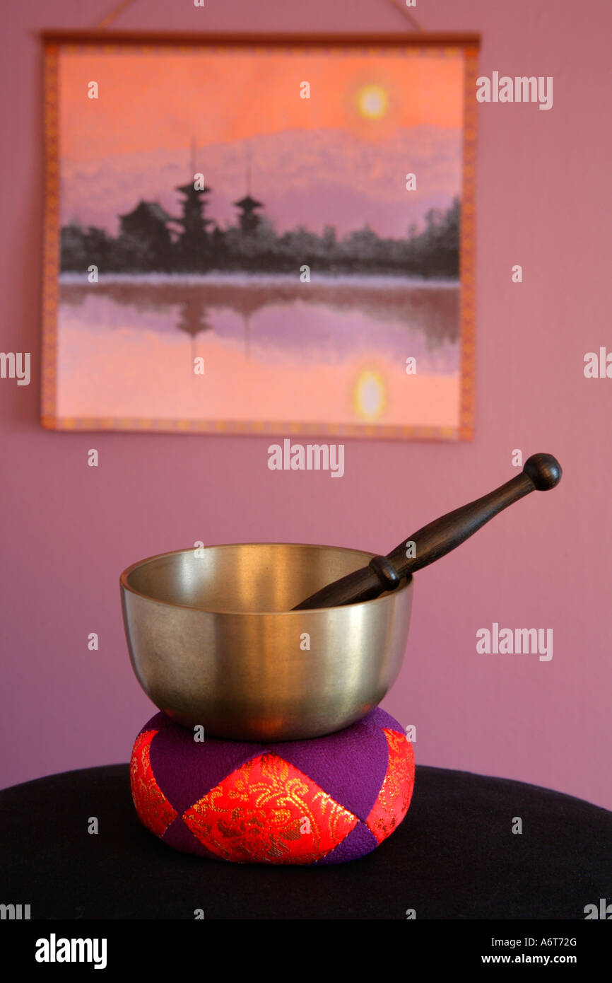 Zen Buddhist Bell Bowl with bell stick on cushion against background ...