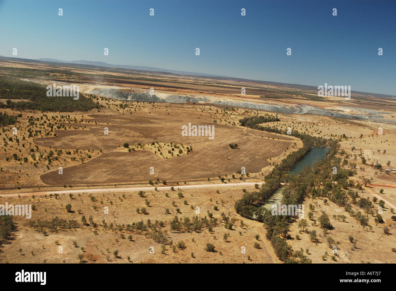 Outback river runs through dry farming land Central Queensland coal ...