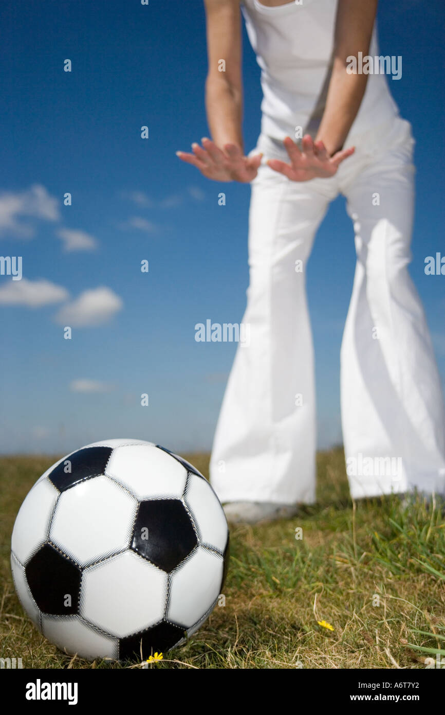 Soccer Ball on Grass in Front of Woman's Legs Stock Photo - Alamy
