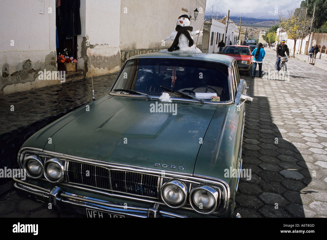 Old Ford car with snowman on roof parked on street in Argentinian ...