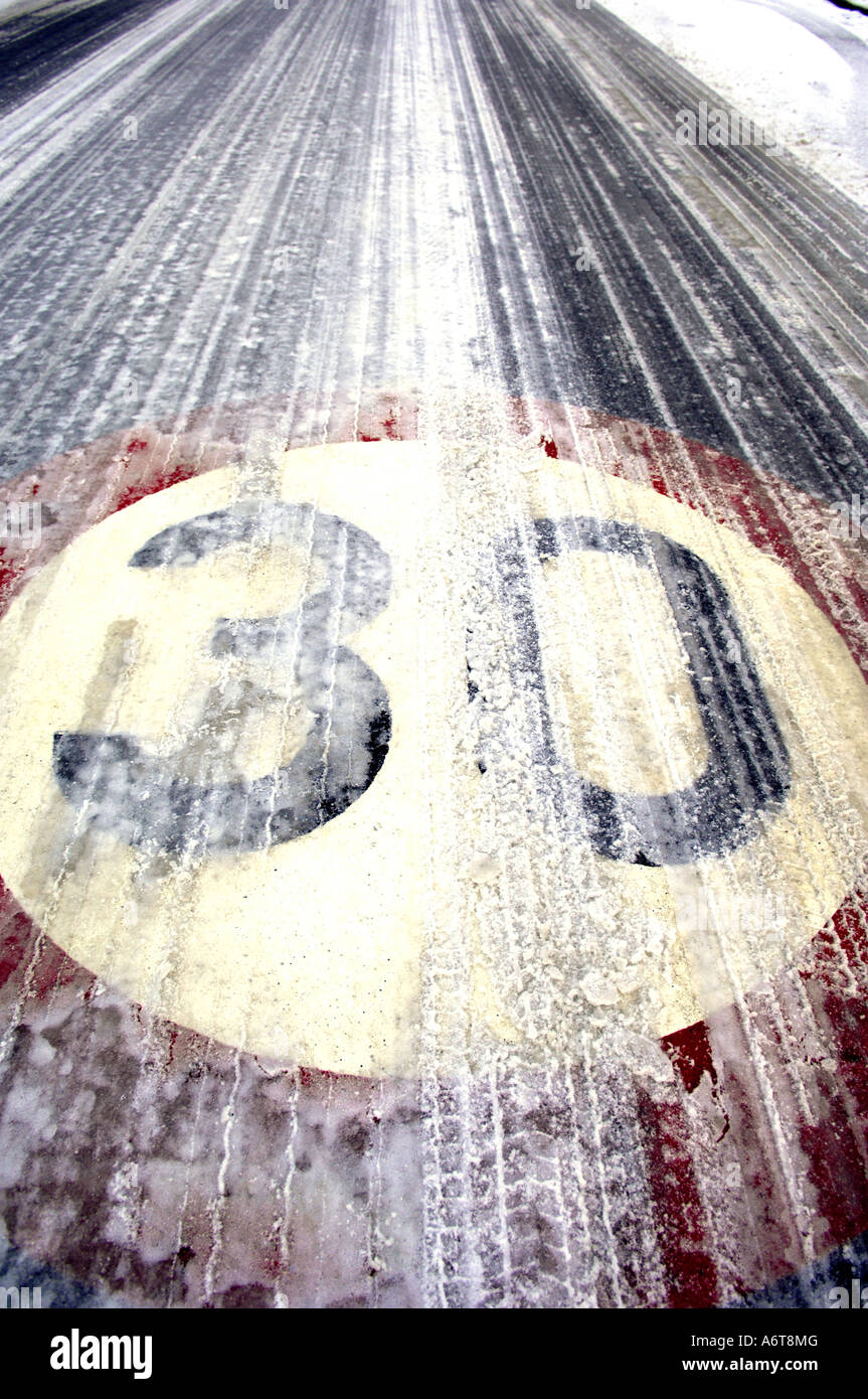 snow covered road 30 thirty zone speed limit red white black ice icy ...