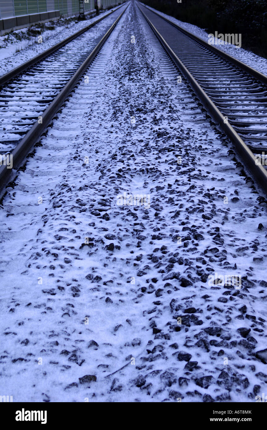 snow covered railway tracks line rail vertical bleak lines colour color ...