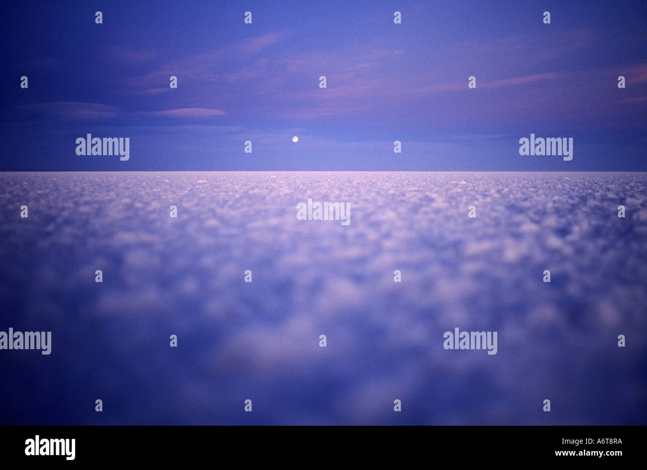 Full moon on vast empty salt flat of Salar de Uyuni at 3600 metres ...