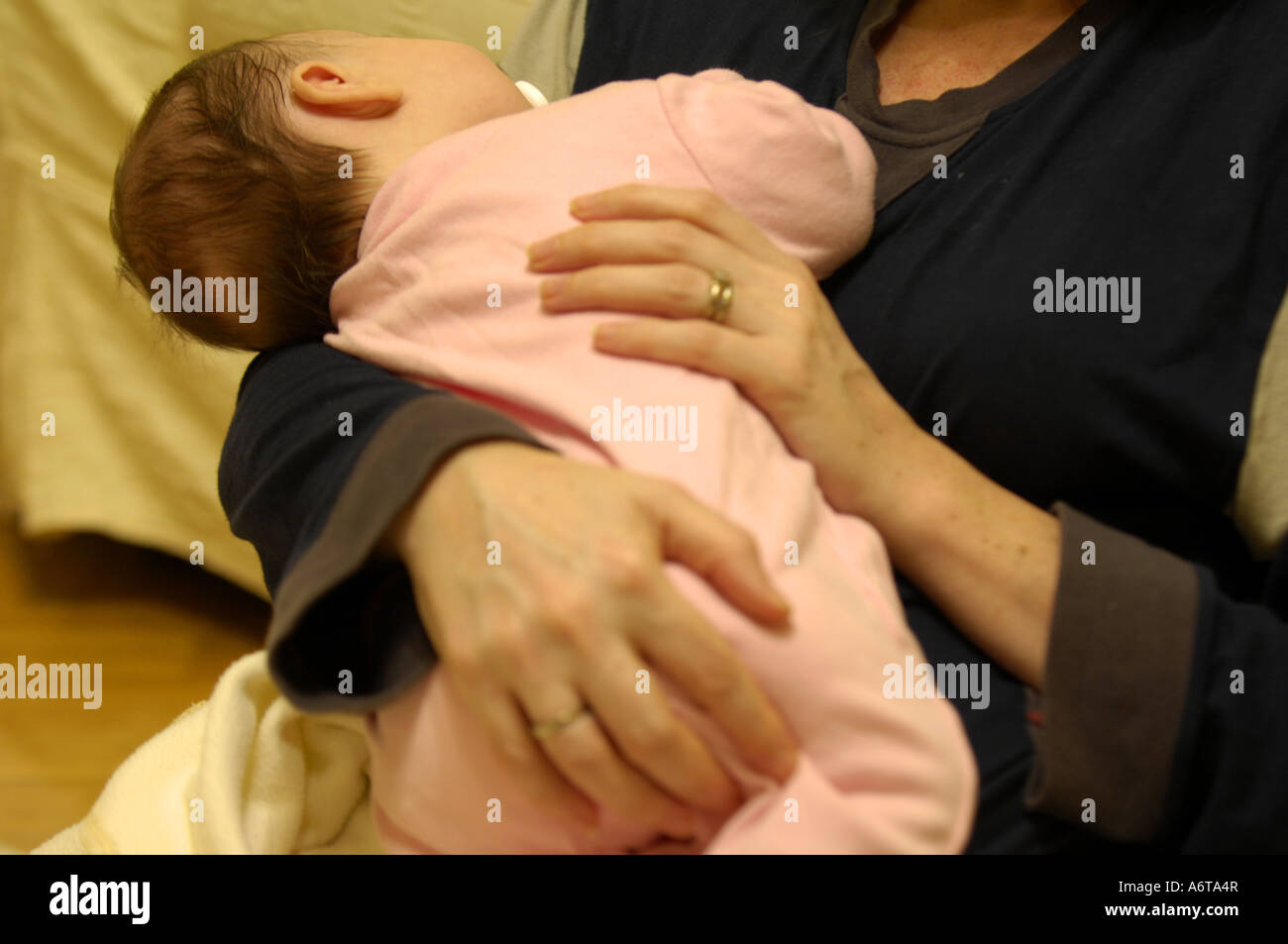 mother holding sleeping sleepy baby hands female woman horizontal ...