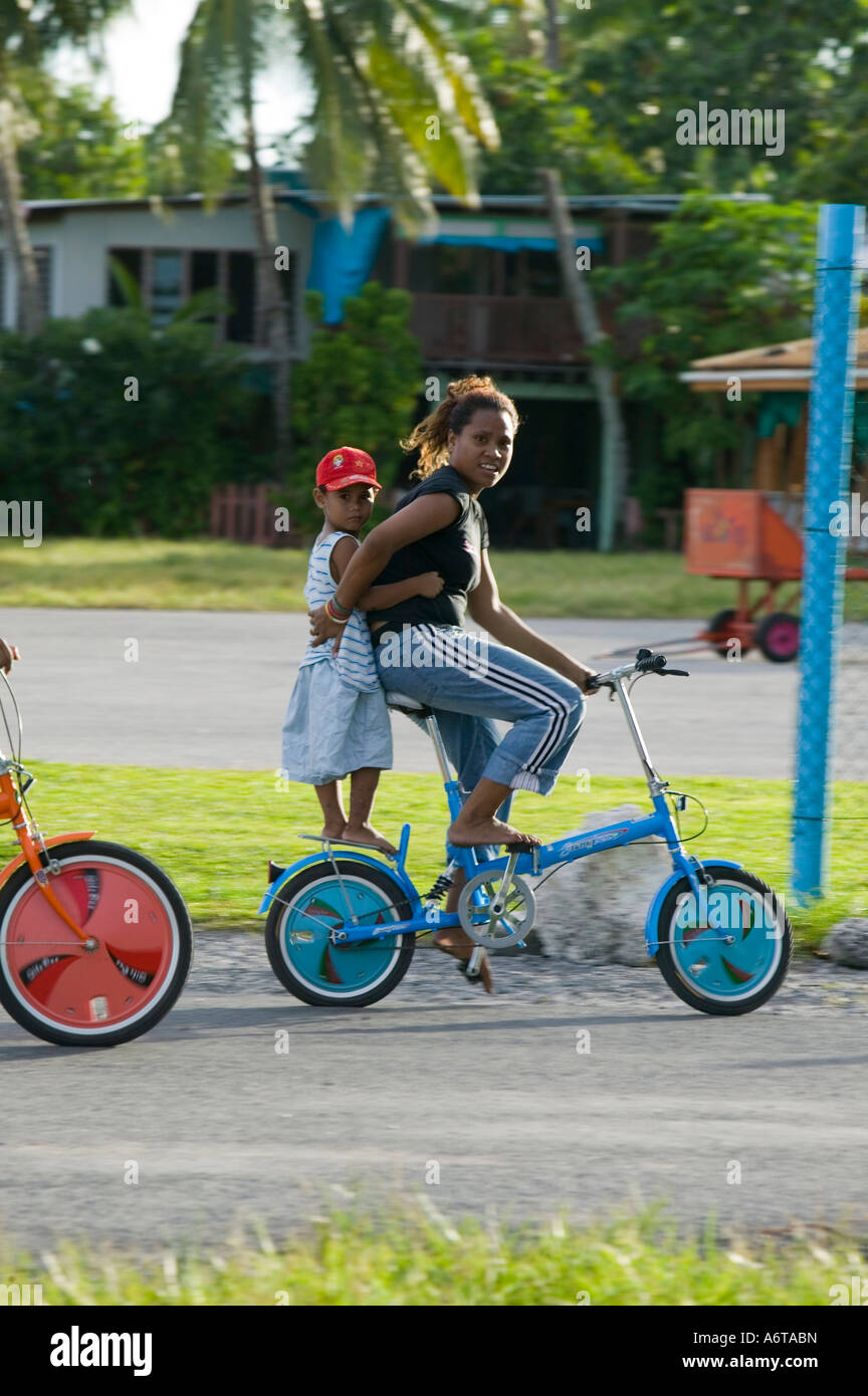 Tuvaluan children playing on a bicycle on Funafuti Stock Photo - Alamy