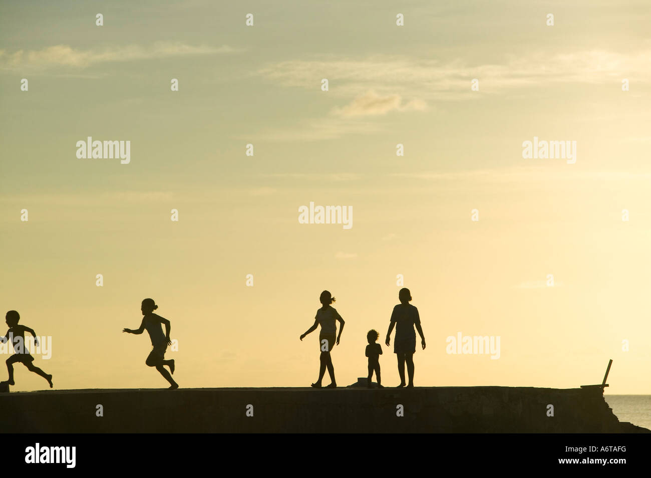 Children playing on the wharf at sunset, Funafuti, Tuvalu Stock Photo ...