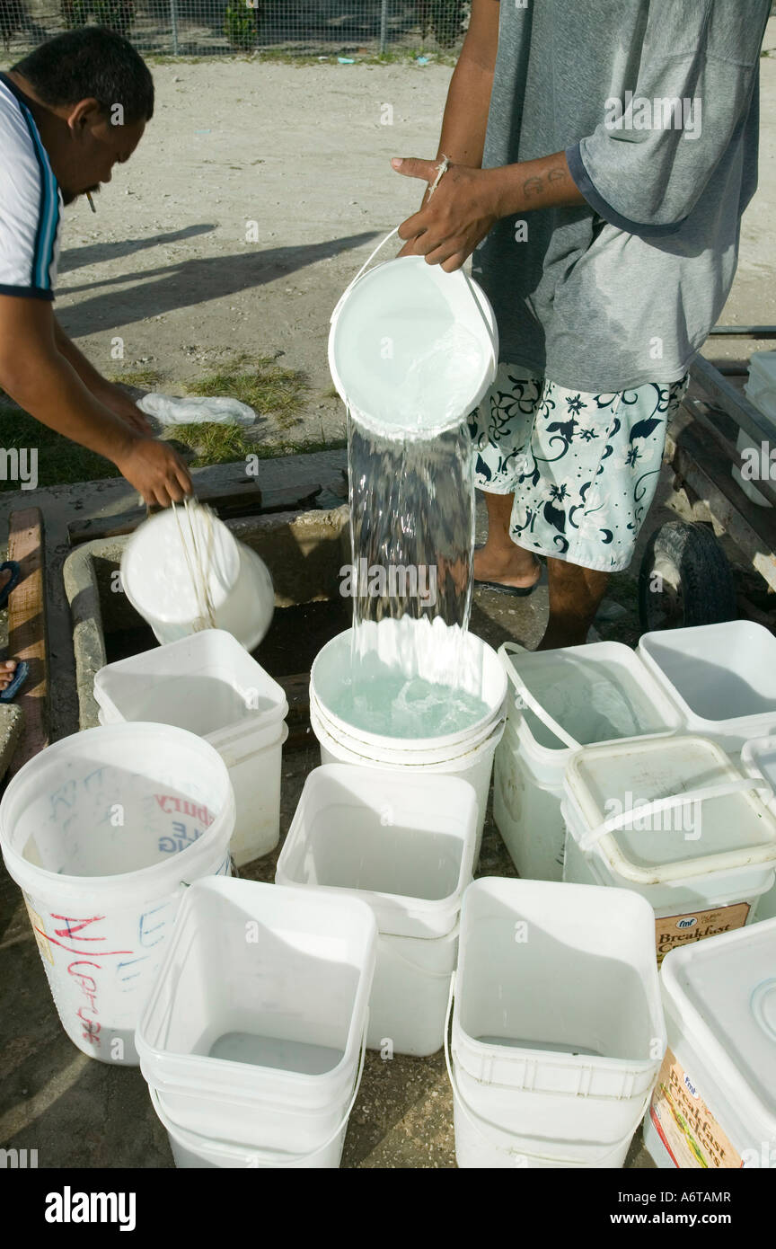 Gathering rain water collected from house rooves on Funafuti, tuvalu ...