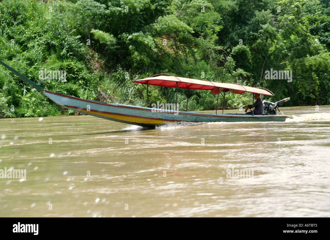 Long-tail boat travelling on Mae Nam Kok river between Tha Ton and ...