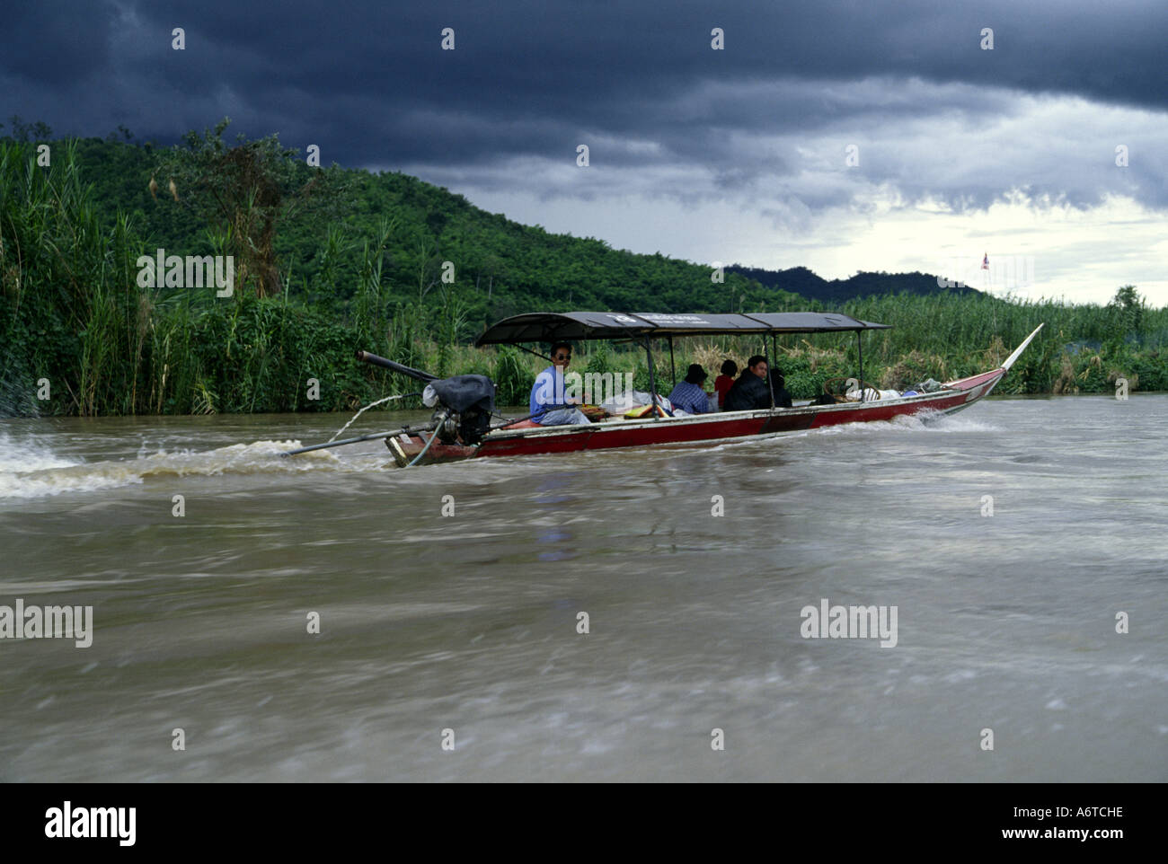 Long tail boat travelling on Mae Nam Kok river between Chiang Rai and ...