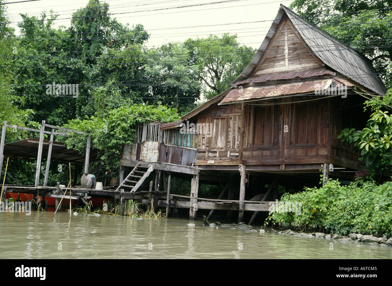 Traditional wooden house on stilts seen in the Klongs Bangkok Thailand ...