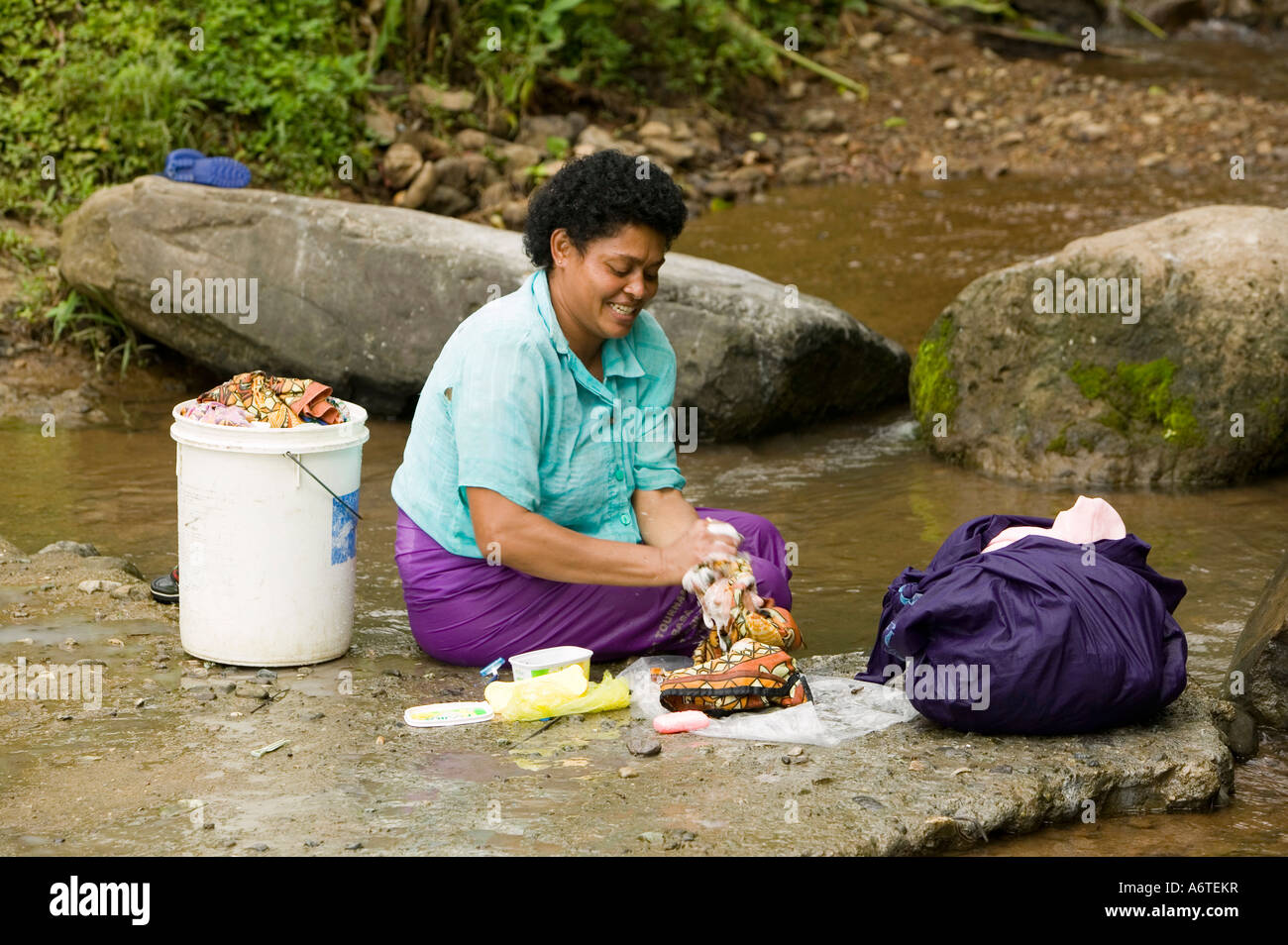 Woman is washing laundry in stream hi-res stock photography and images ...