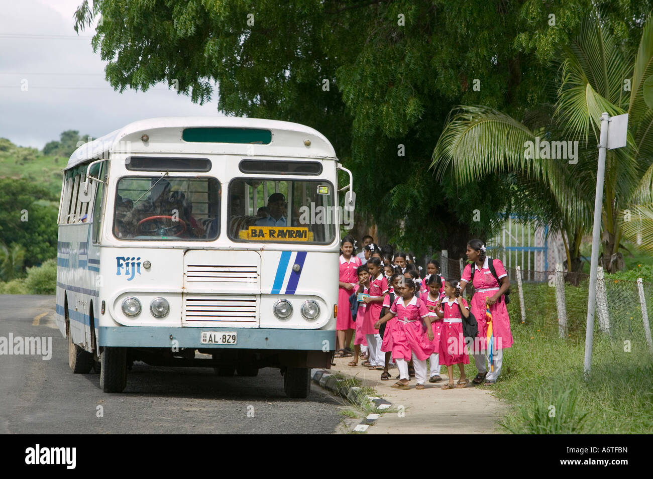 Indian children getting on the school bus in Fiji Stock Photo - Alamy