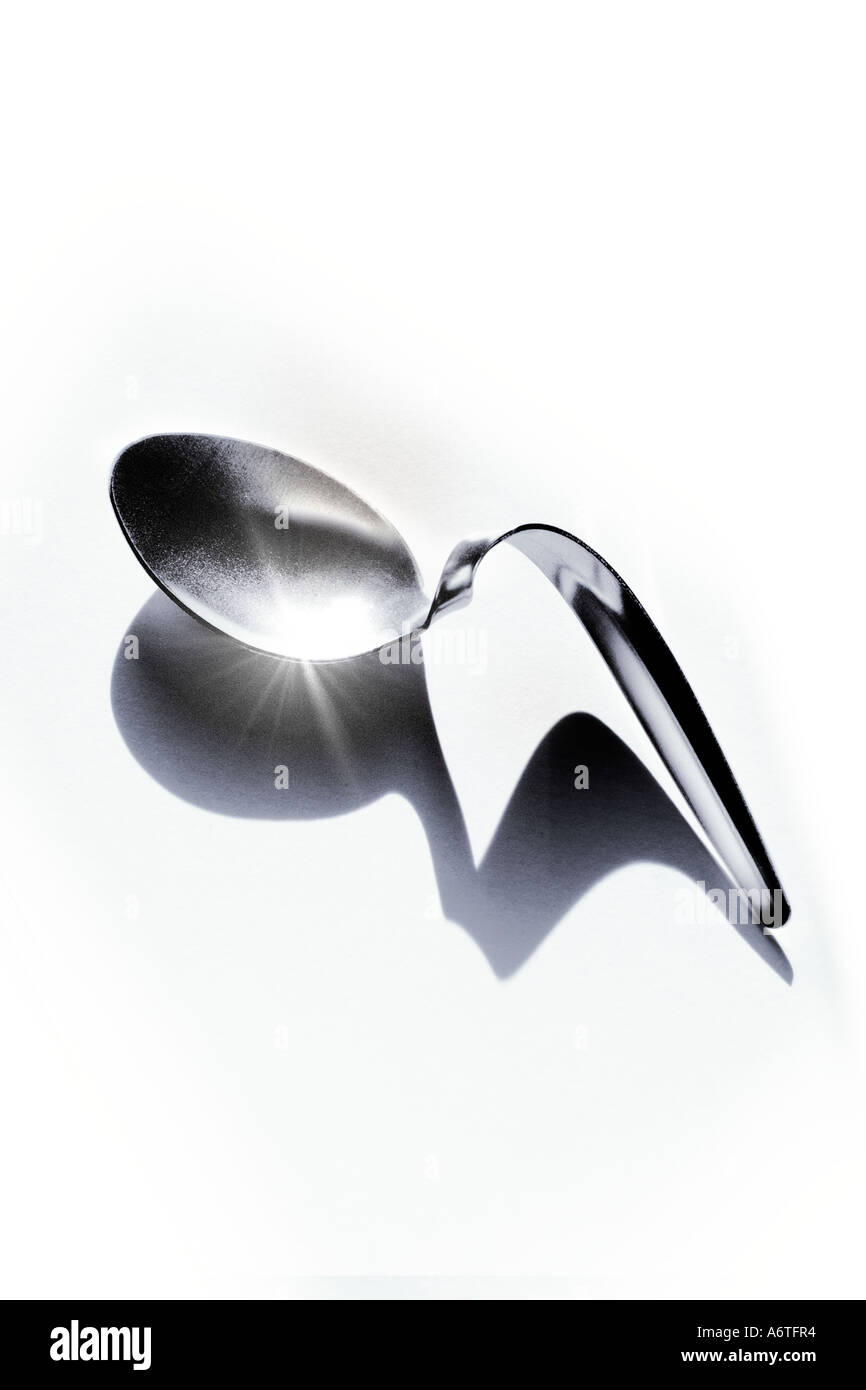 A bent shiny metal spoon Stock Photo - Alamy