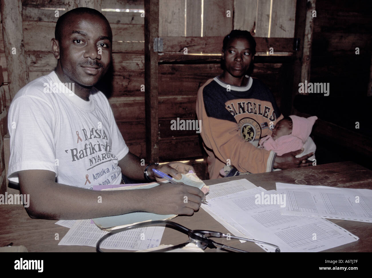 Africa, Tanzania, western Tanzania. Health worker interviews mother ...
