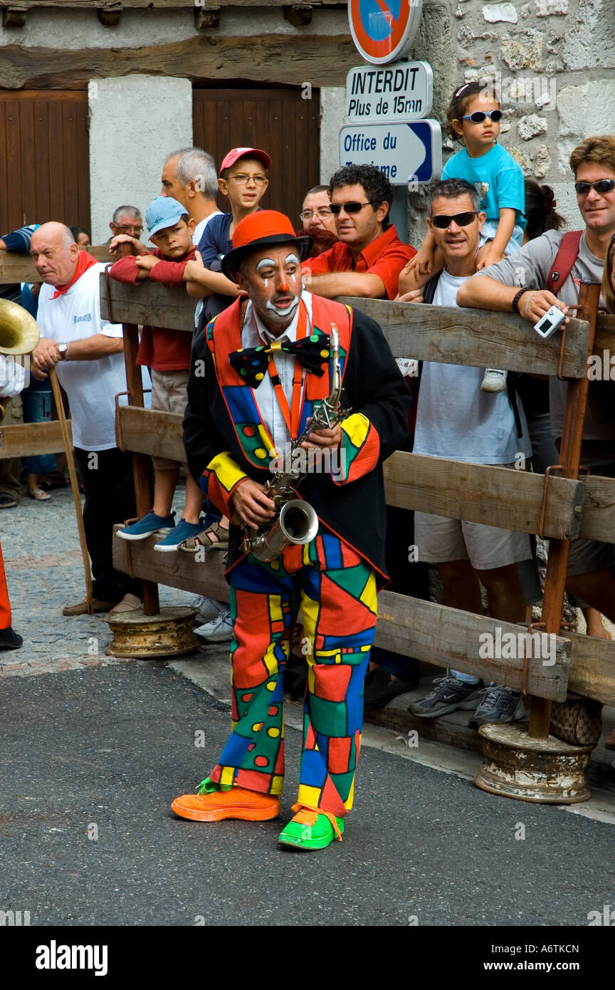 a clown entertains the crowds before the bull running at the Feria de ...