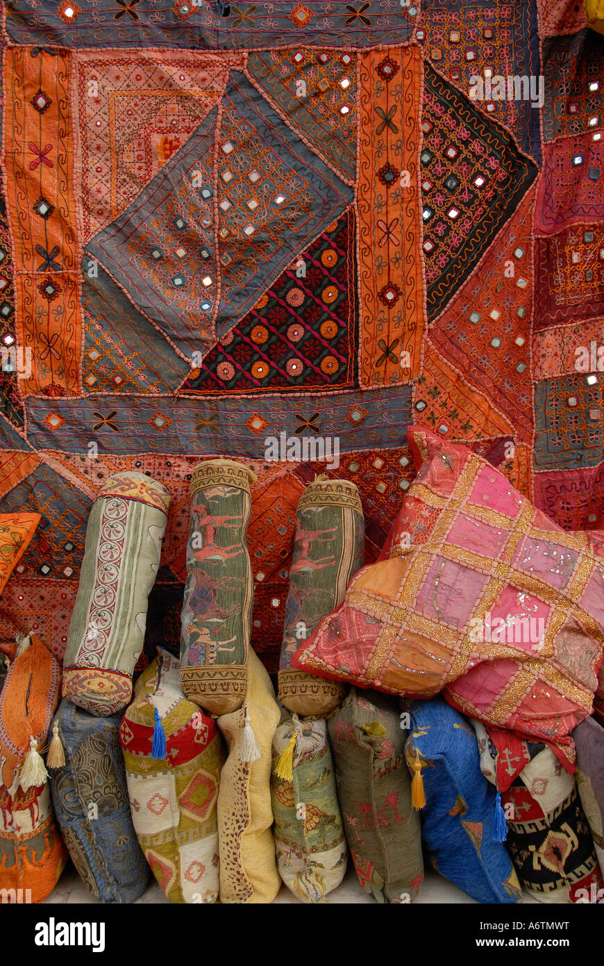 Richly coloured traditional fabric for sale at the market in a bazaar ...