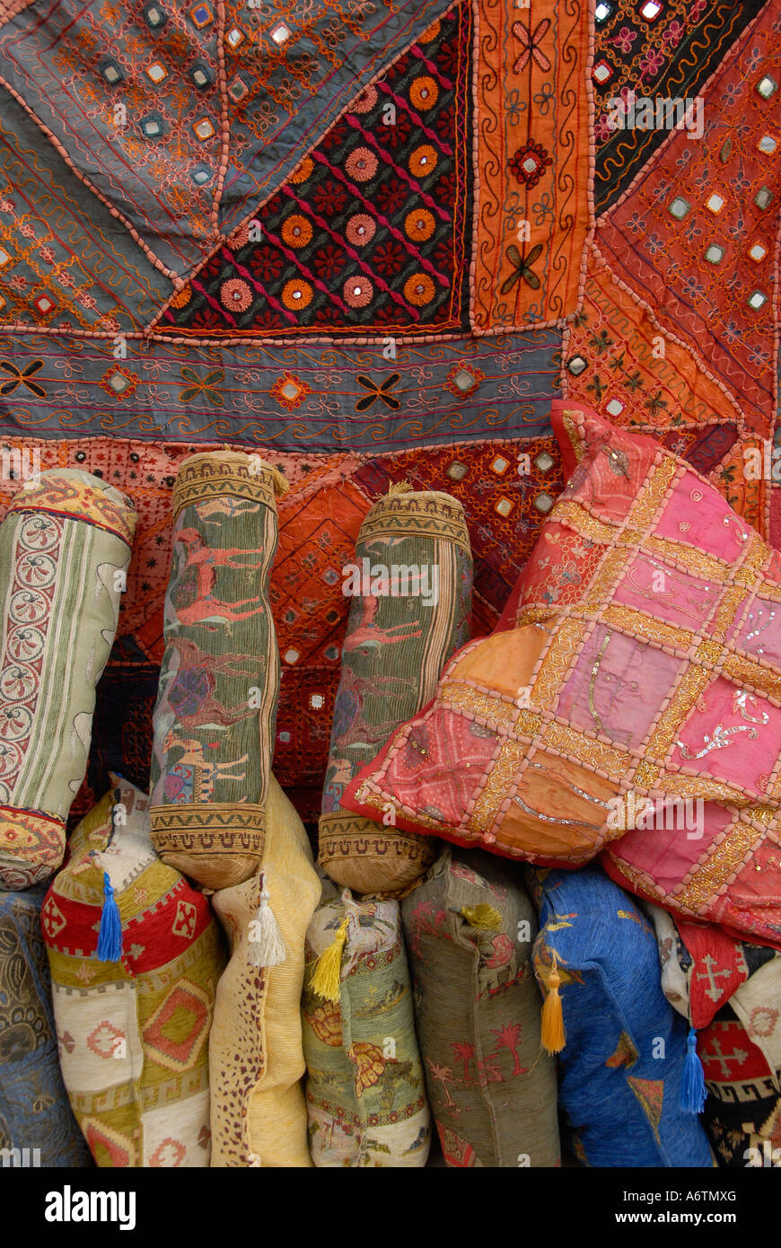 Richly coloured traditional fabric for sale at the market in a bazaar ...