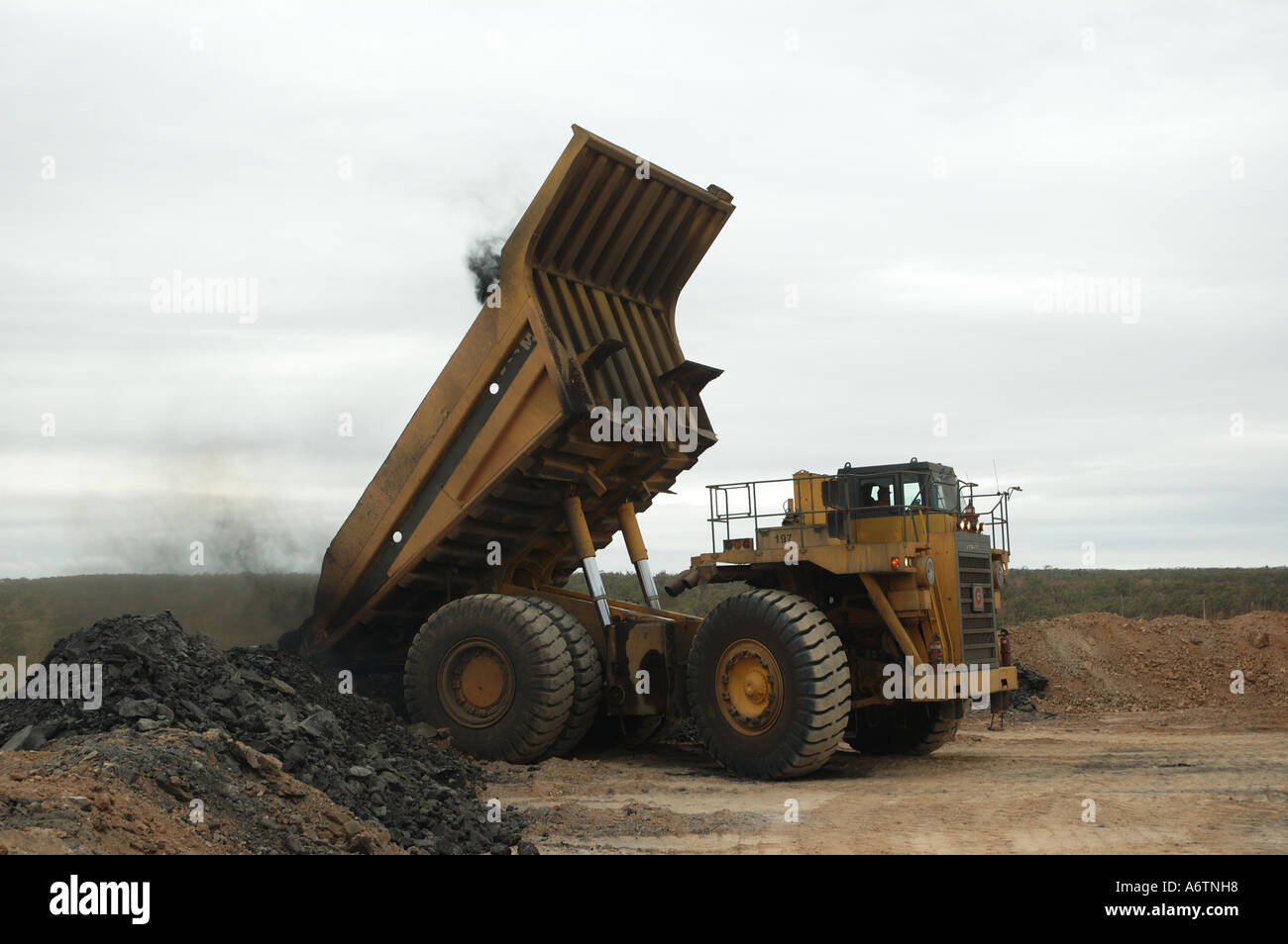 Huge dump truck unloading rock Stock Photo - Alamy