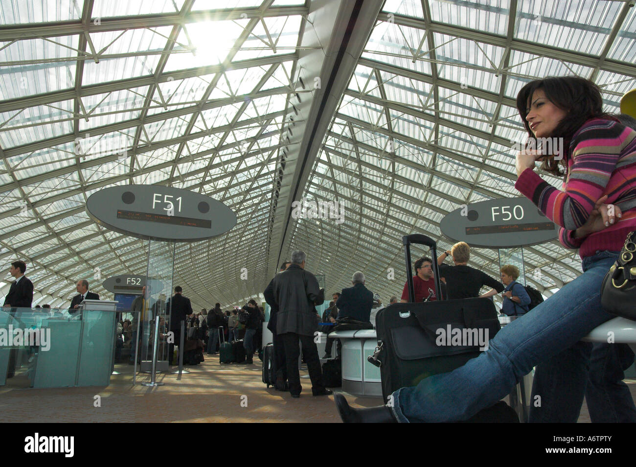 France Paris CDG airport woman seating and waiting in frgd with glass ...