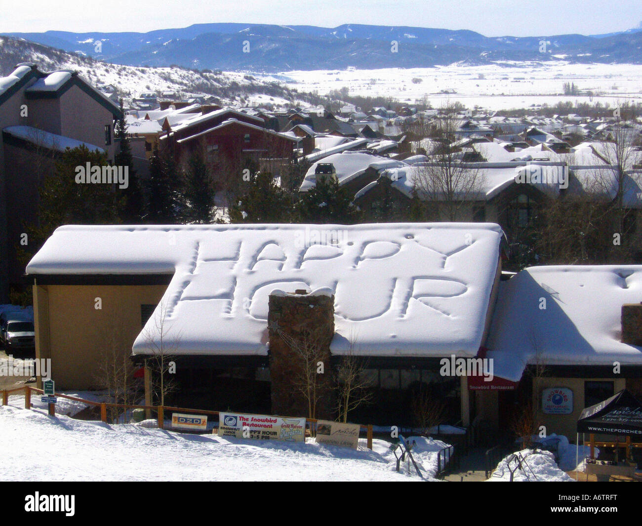 Ski resort pub with 'Happy Hour' written on the roof in the snow Stock ...