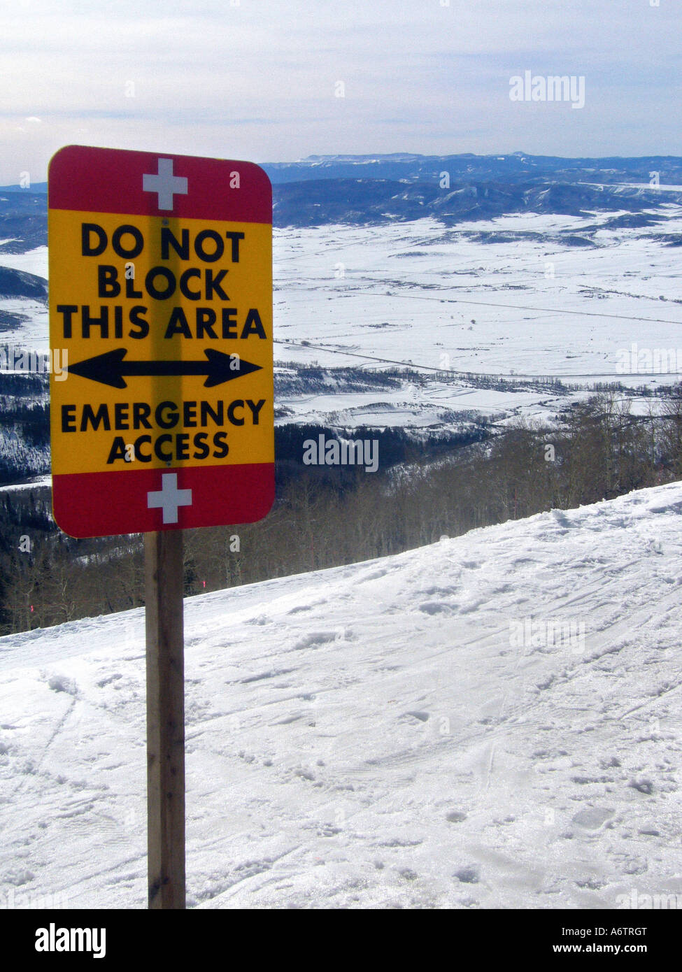 warning sign on edge of snowy mountain Stock Photo - Alamy