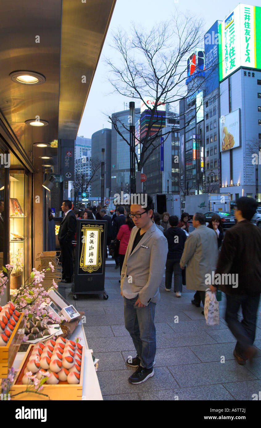 Japan Honshu Tokyo Ginza young man looking at sweet display on pavement ...