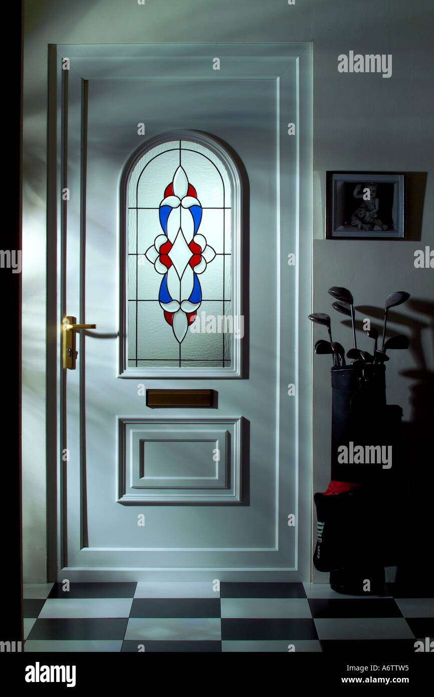 Hallway of home with laminate flooring and white Upvc front door with ...