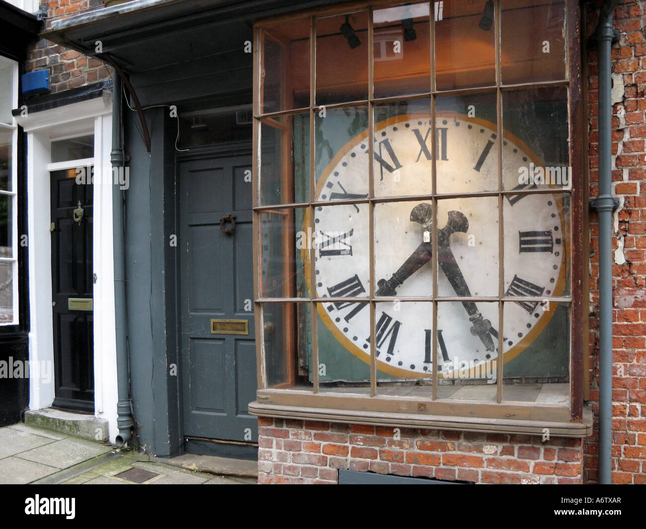 Large Clock in Shop Window Stock Photo - Alamy