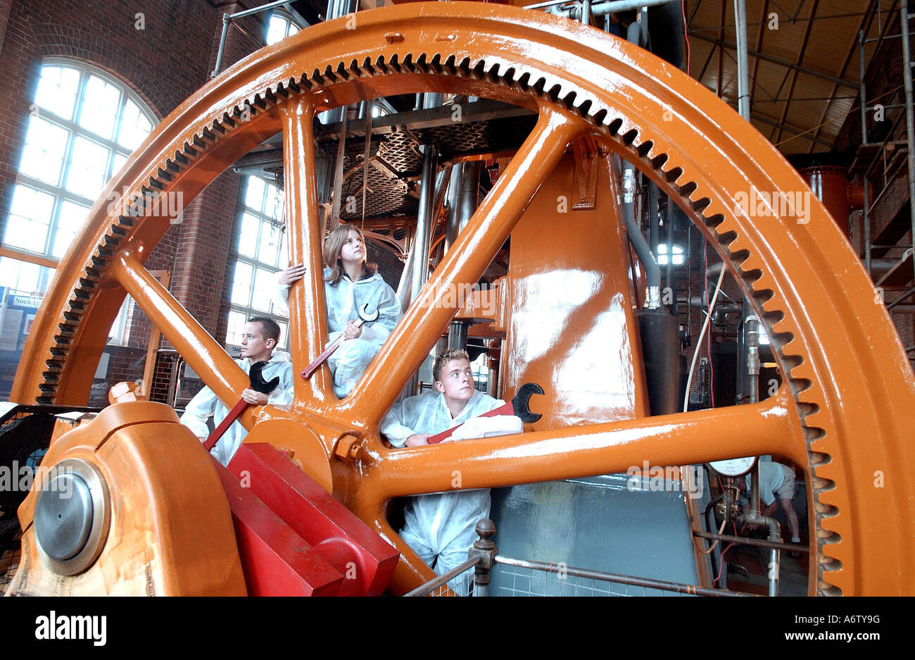 One girl and two boy Southern Water apprentice engineers with a steam ...