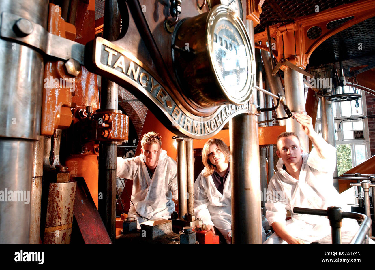 One girl and two boy Southern Water apprentice engineers with a steam ...