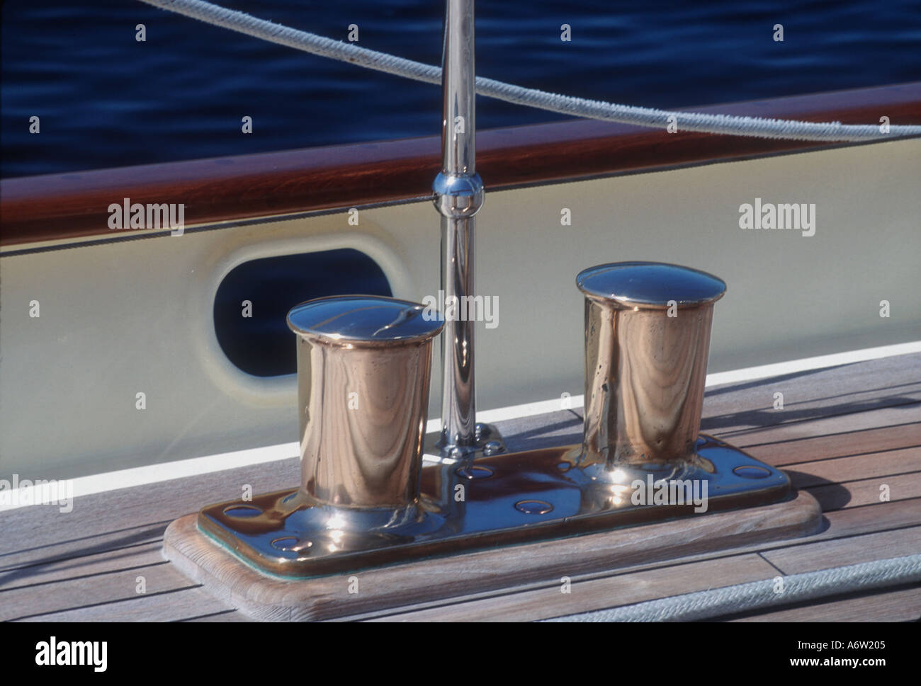 Brass Bollard on a teak classic yacht deck and a fairlead in the ...