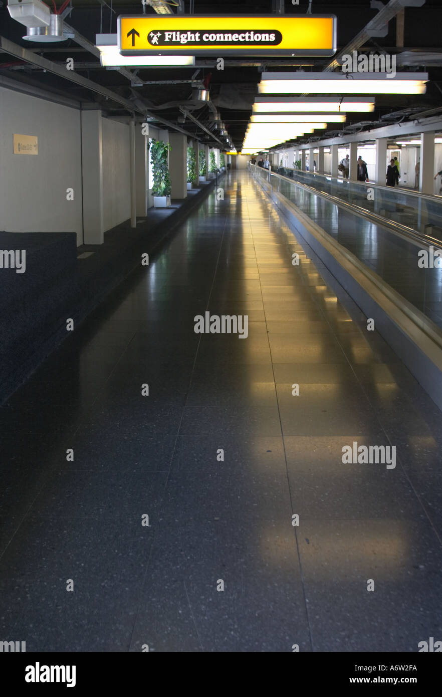 Flight connections sign above a long corridor at London Heathrow ...