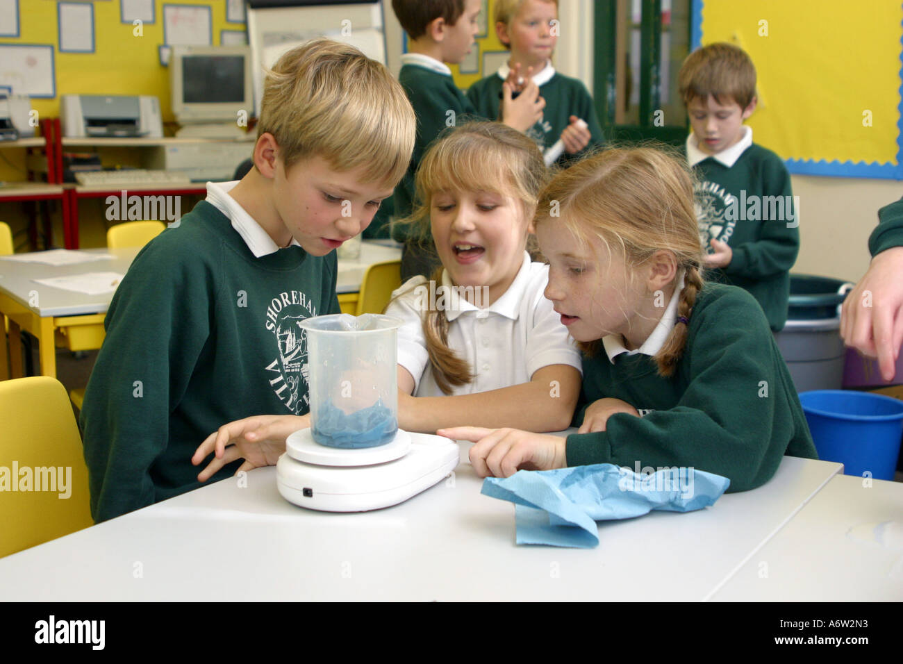 primary school children in village school using scales in science ...