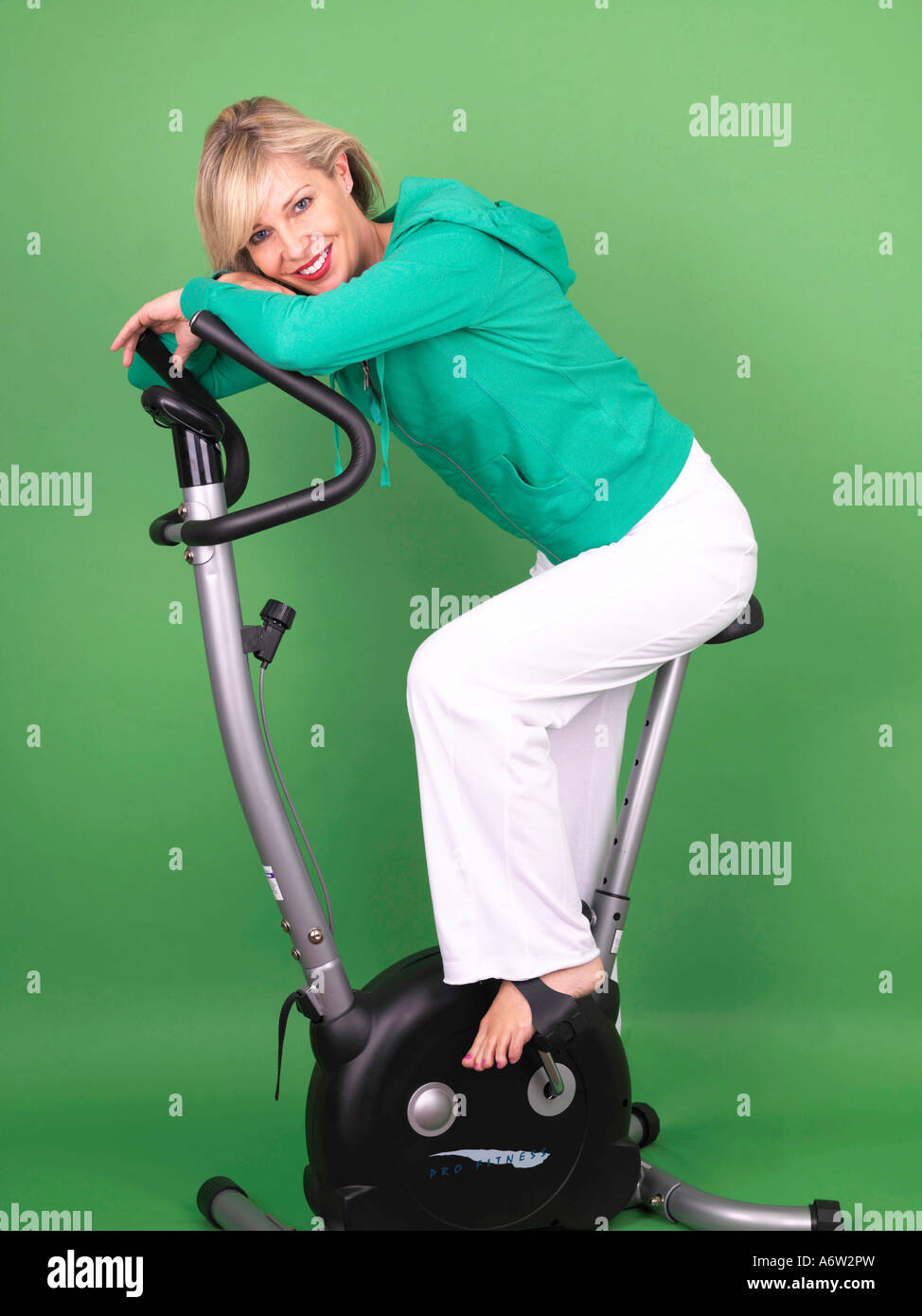 Woman Using Exercise Bike Model Released Stock Photo - Alamy