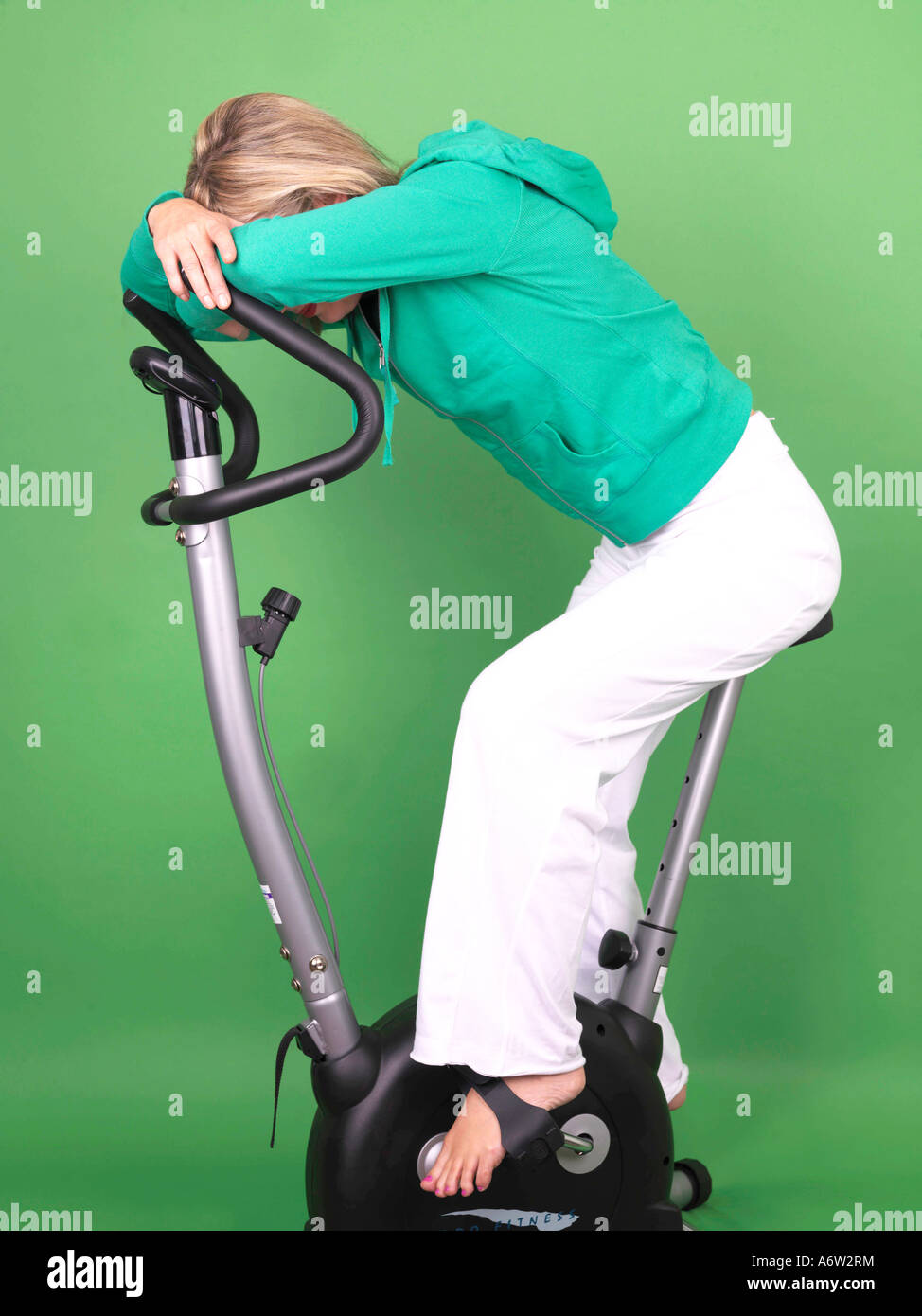 Woman Using Exercise Bike Model Released Stock Photo - Alamy