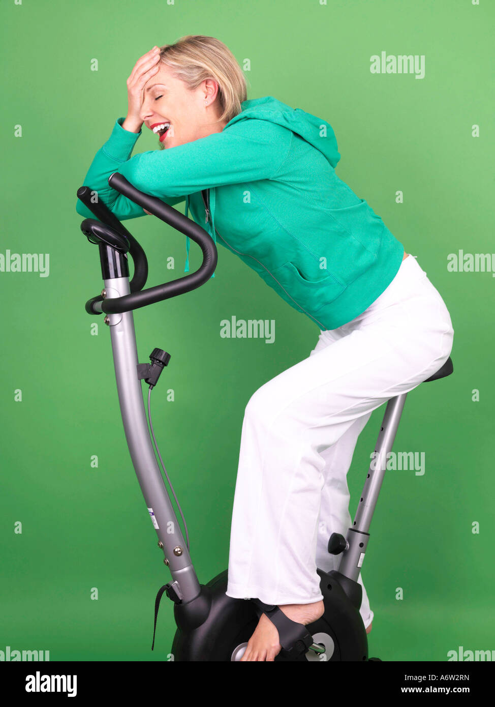 Woman Using Exercise Bike Model Released Stock Photo - Alamy