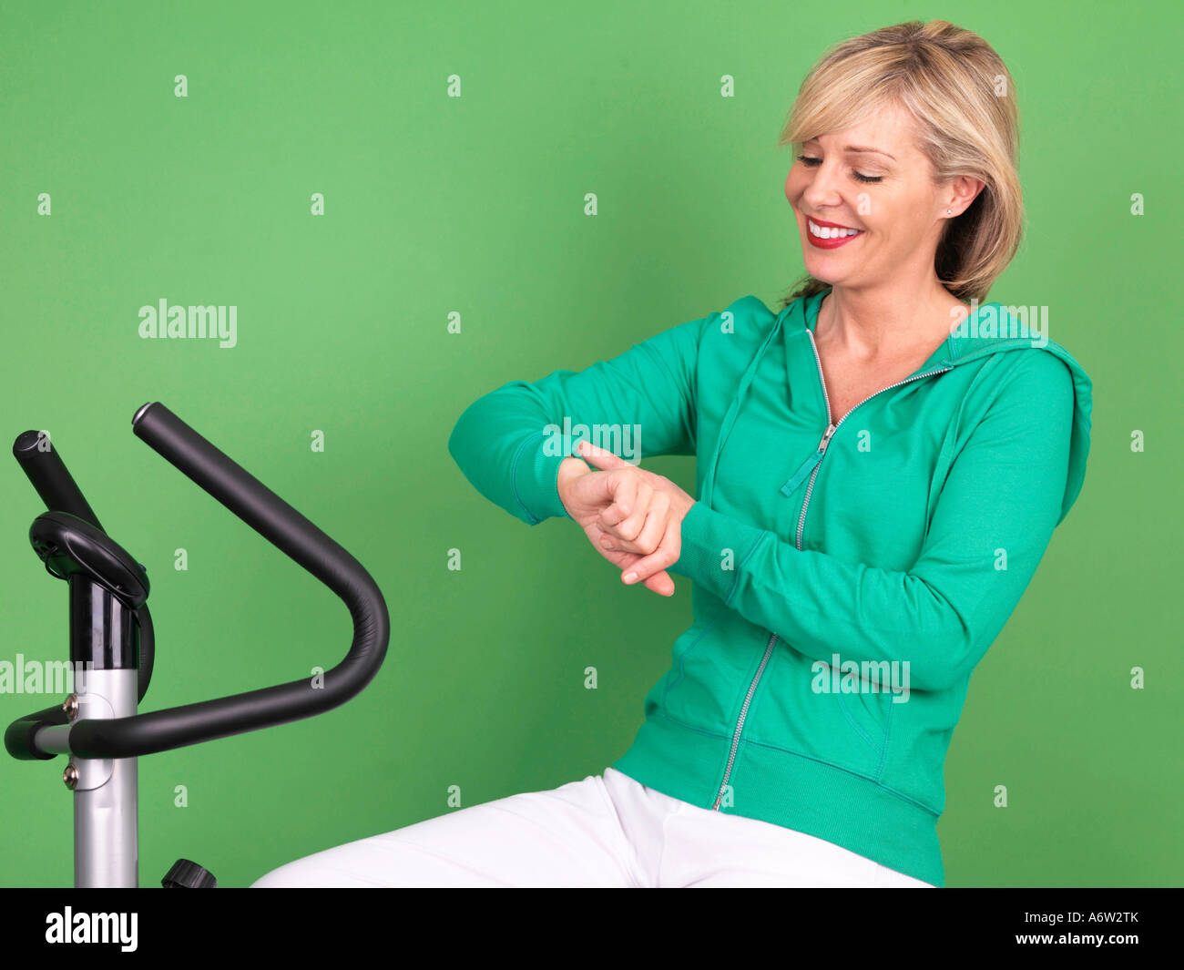 Woman Using Exercise Bike Model Released Stock Photo - Alamy