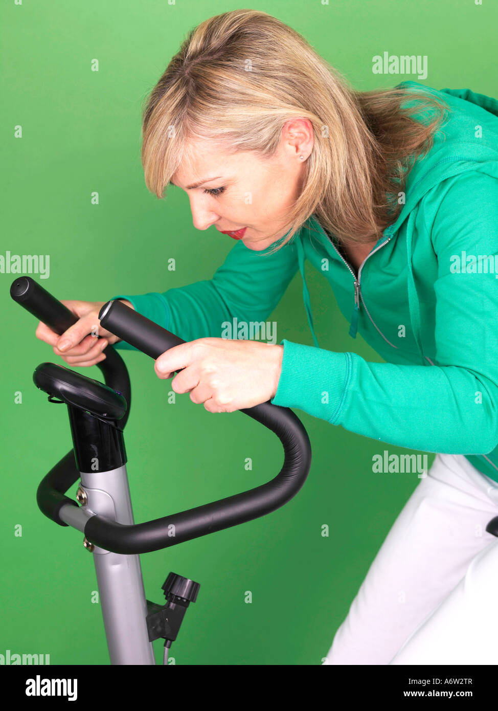 Woman Using Exercise Bike Model Released Stock Photo - Alamy