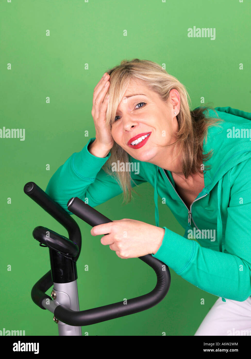 Woman Using Exercise Bike Model Released Stock Photo - Alamy