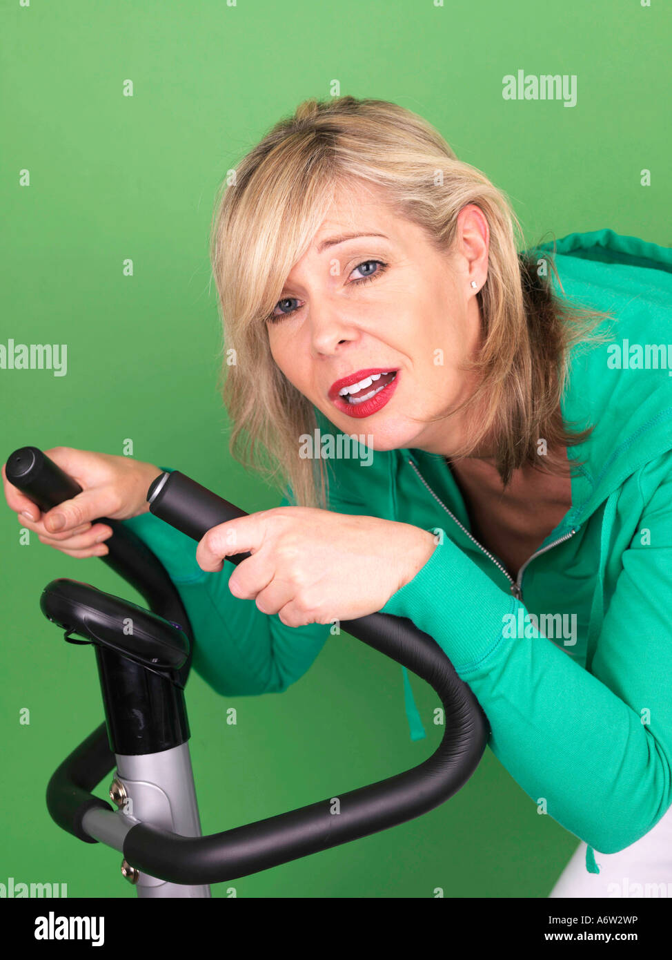 Woman Using Exercise Bike Model Released Stock Photo - Alamy