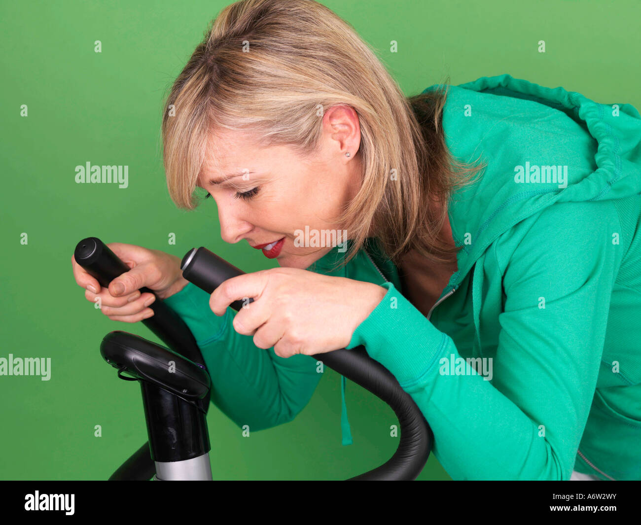 Woman Using Exercise Bike Model Released Stock Photo - Alamy