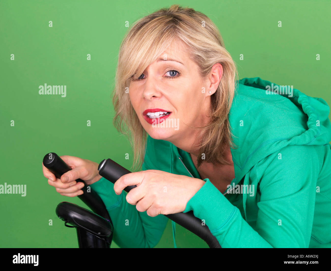 Woman Using Exercise Bike Model Released Stock Photo - Alamy