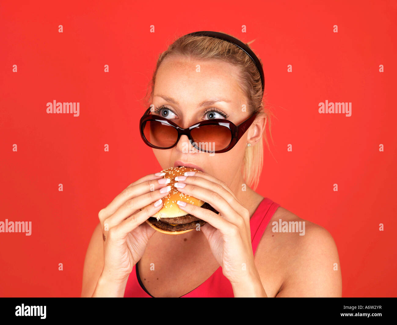 Young Woman Eating Cheeseburger Model Released Stock Photo - Alamy