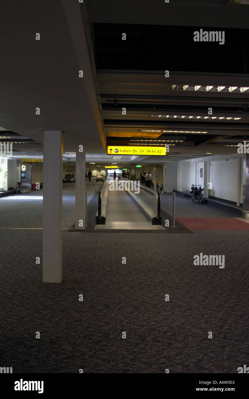 Gate 26 28 30 to 42 sign above a long travelator at London Heathrow ...