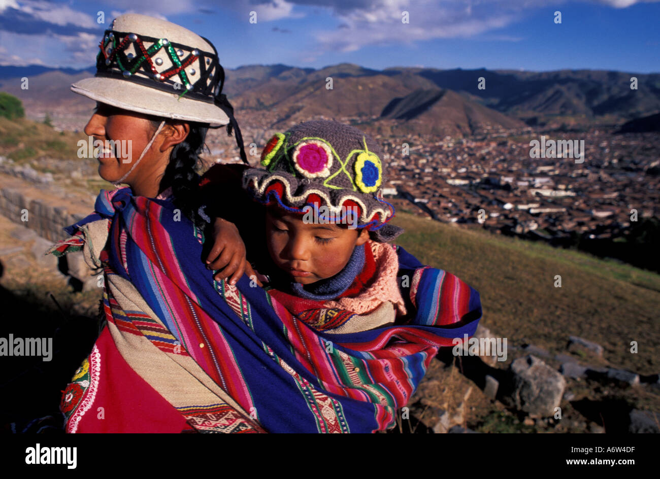 Peruvian mother carries her 3 years old child in the back near Machu ...