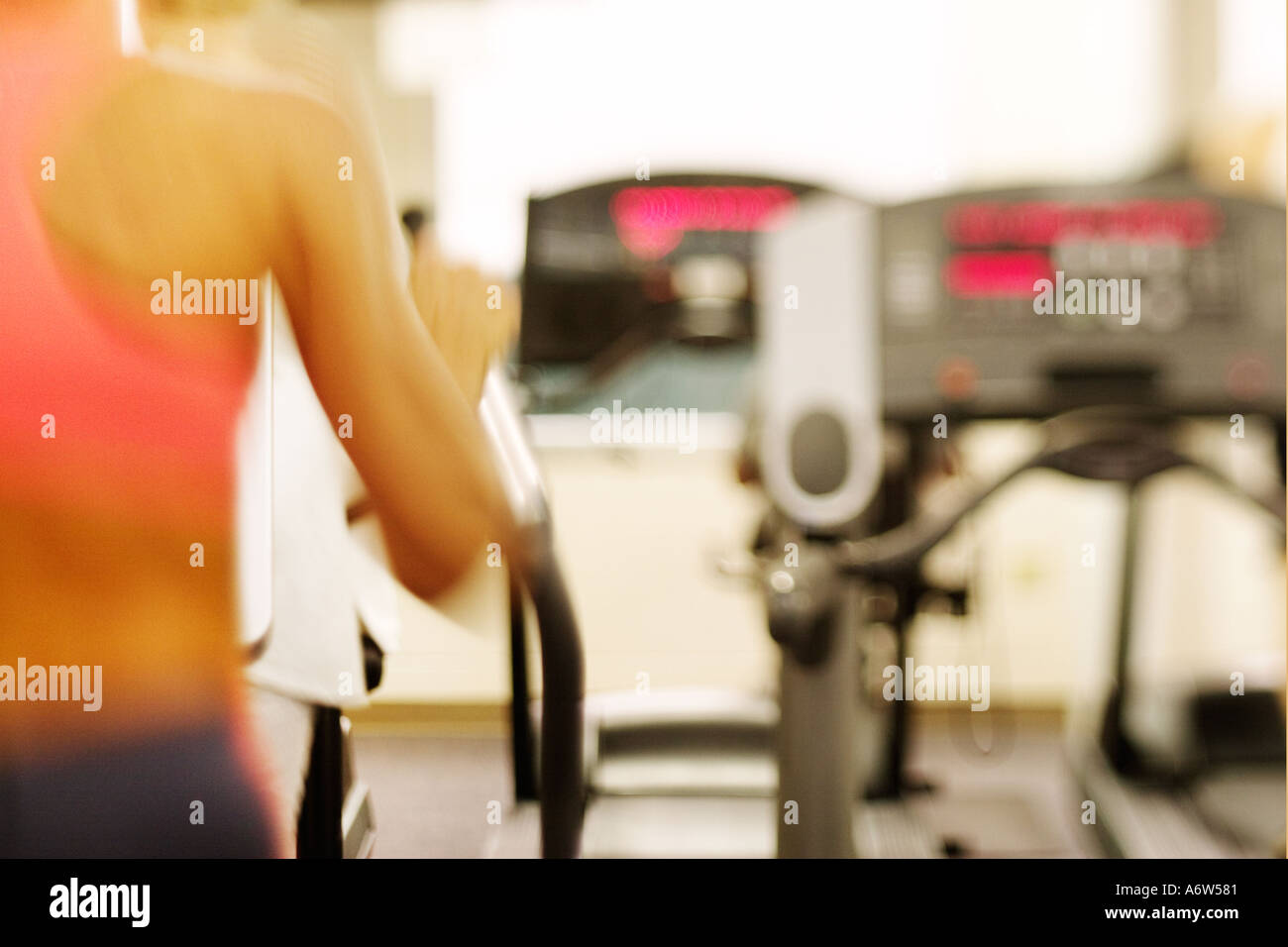 working out on treadmill or elliptical trainer Stock Photo - Alamy