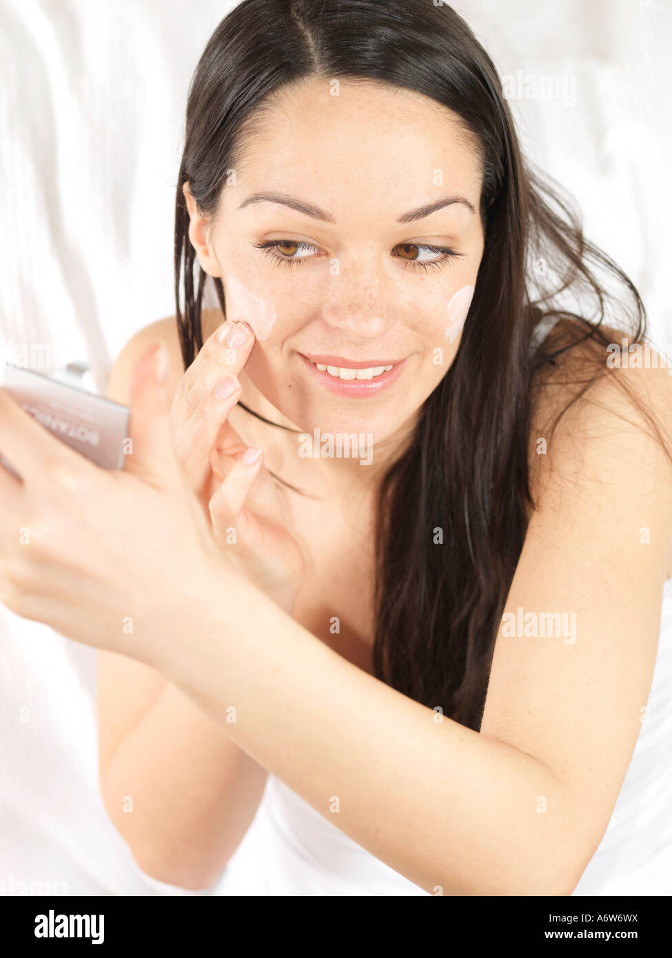 Young Woman Applying Face Cream Model Released Stock Photo - Alamy